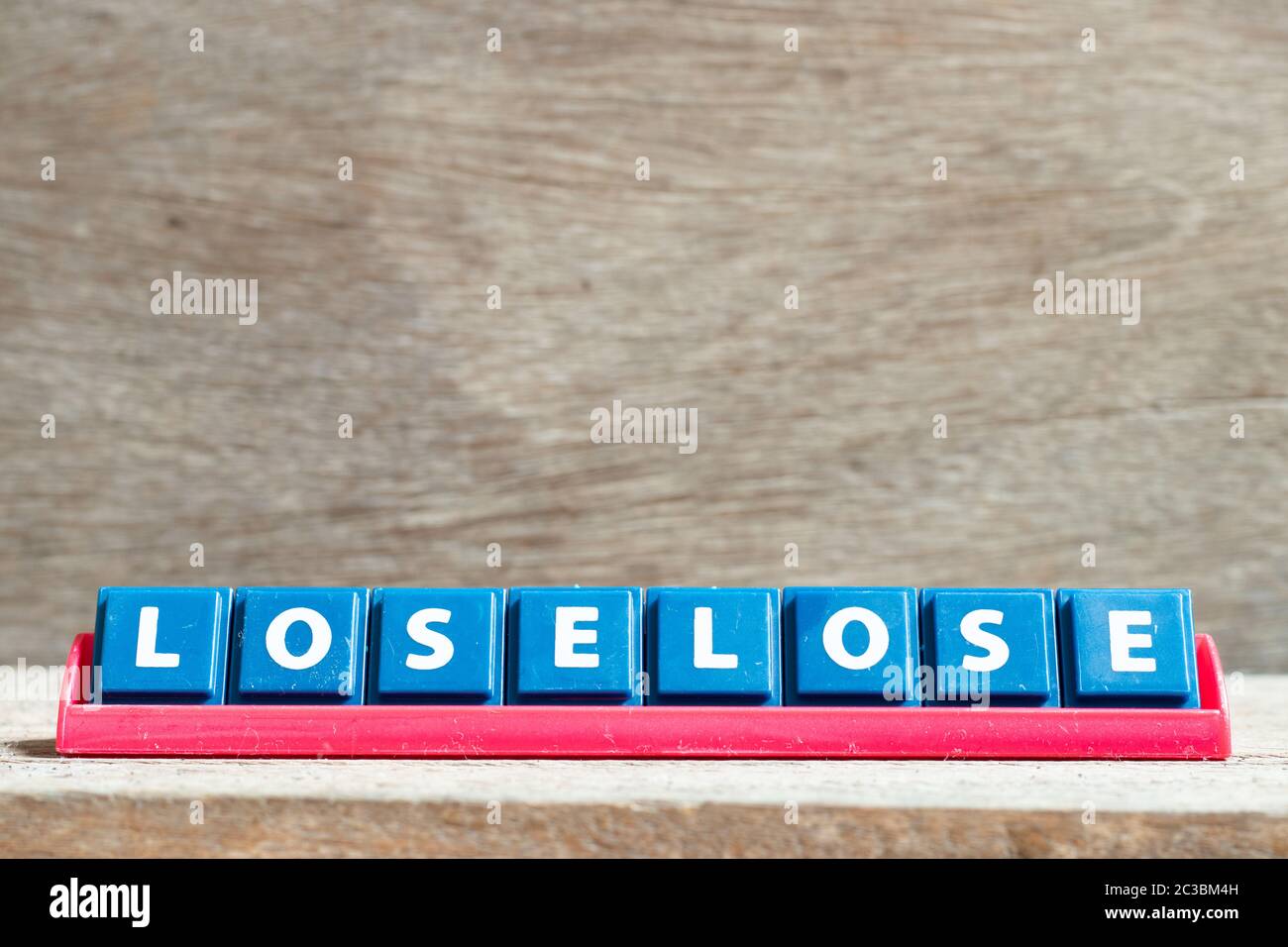 Tile letter on red rack in word lose lose on wood background Stock ...