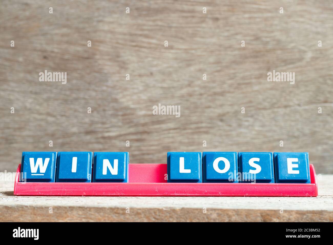 Tile letter on red rack in word win lose on wood background Stock Photo ...
