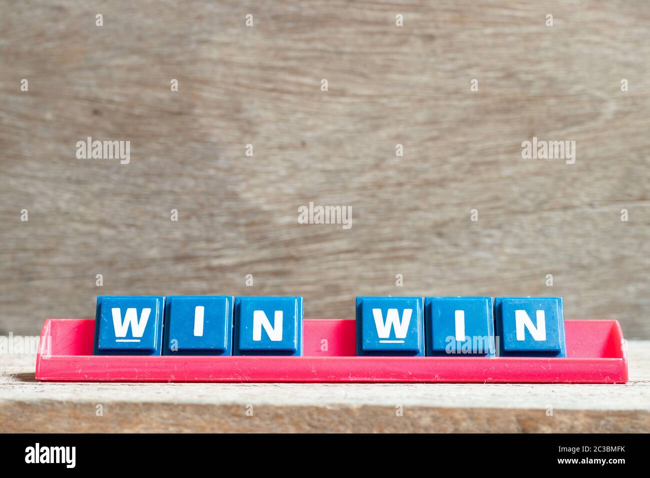Tile letter on red rack in word win win on wood background Stock Photo ...