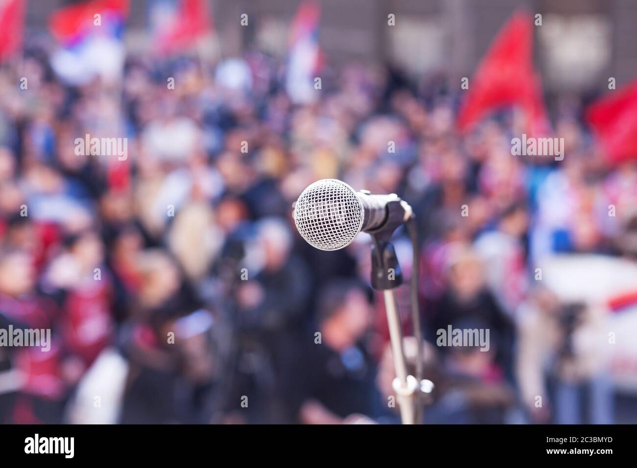 Microphone in focus against blurred crowd Stock Photo - Alamy