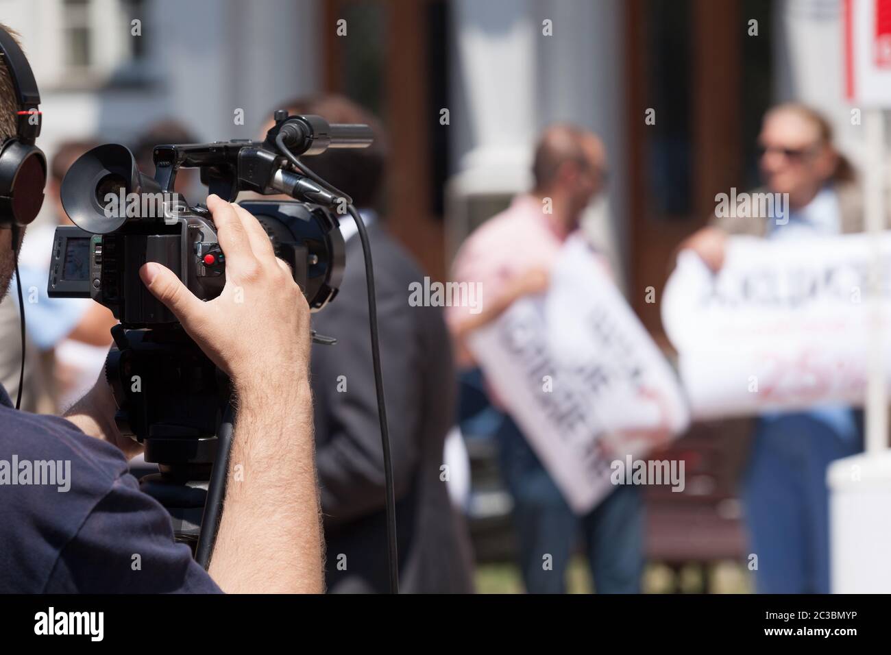 Filming public demonstration with a video camera Stock Photo - Alamy