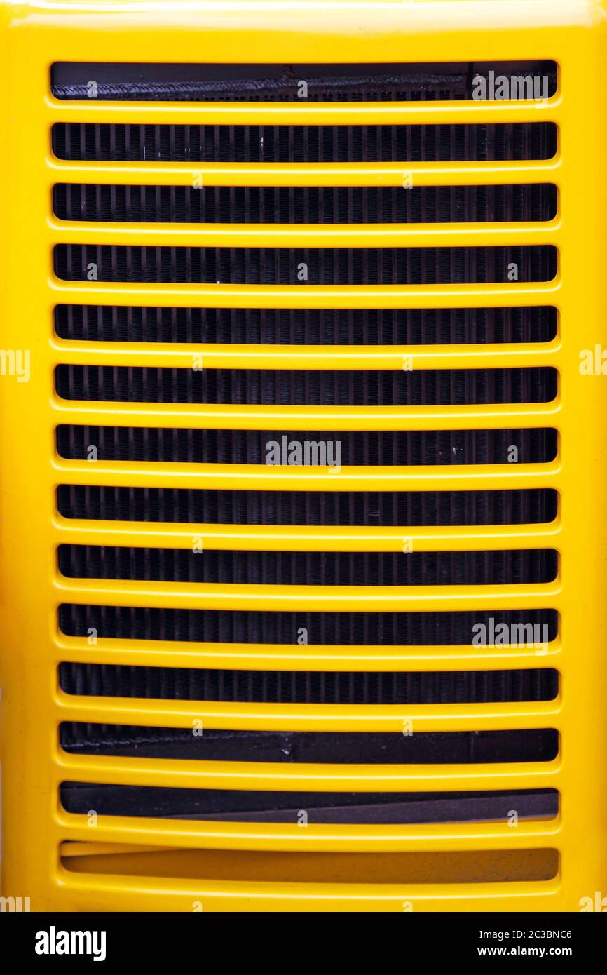 Yellow radiator cooling grill at construction machine Stock Photo - Alamy