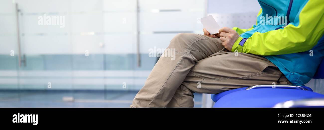 Man in sportswear is waiting on chair in hallway Stock Photo - Alamy