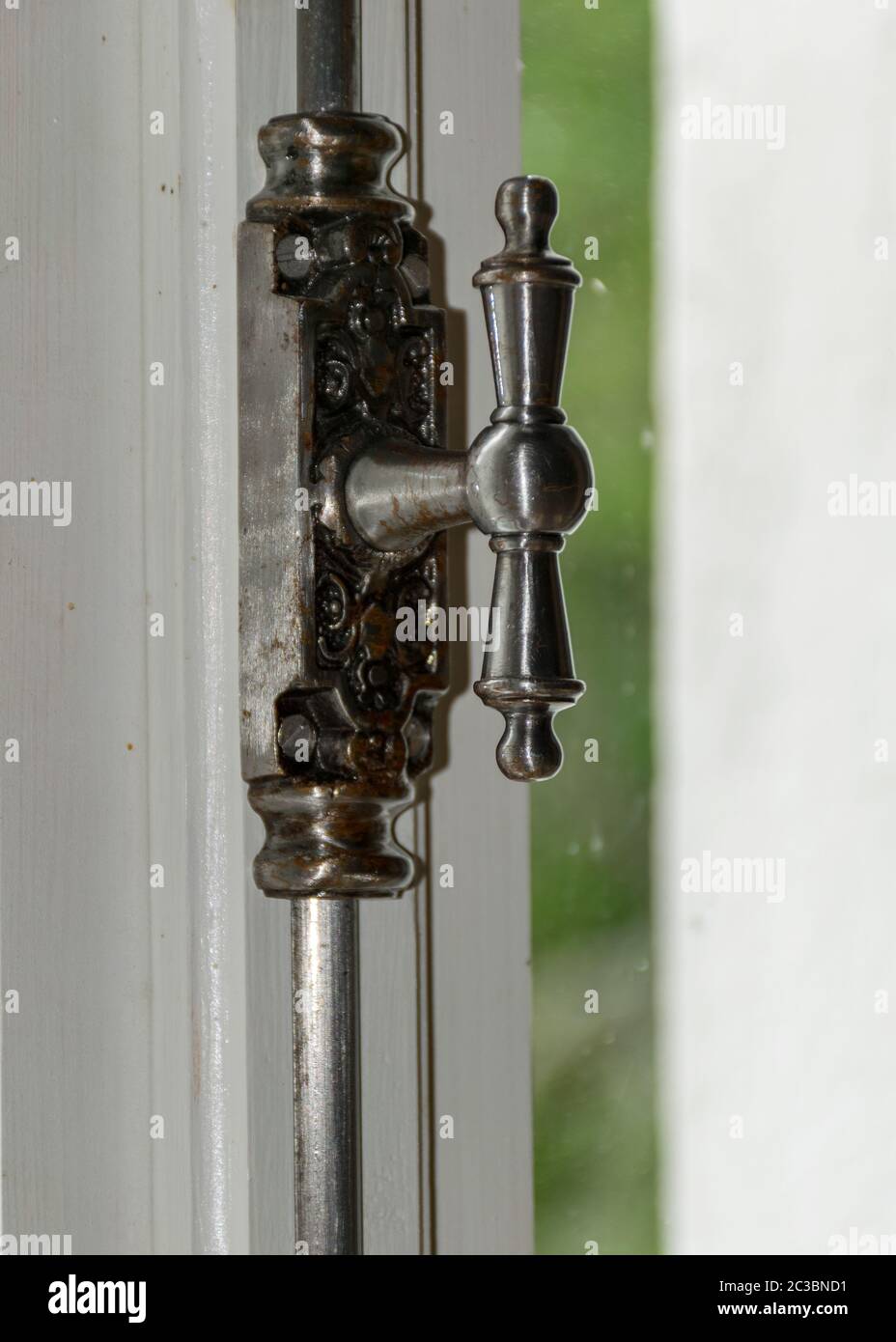 photo with ancient window opening handle, white old wooden window frame ...