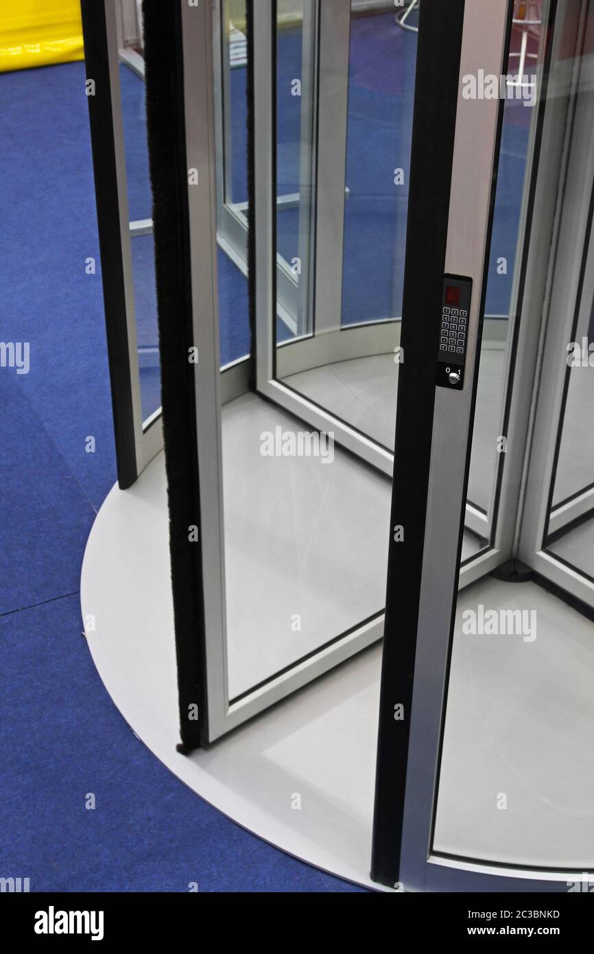 Automatic revolving glass door with electronic lock Stock Photo - Alamy
