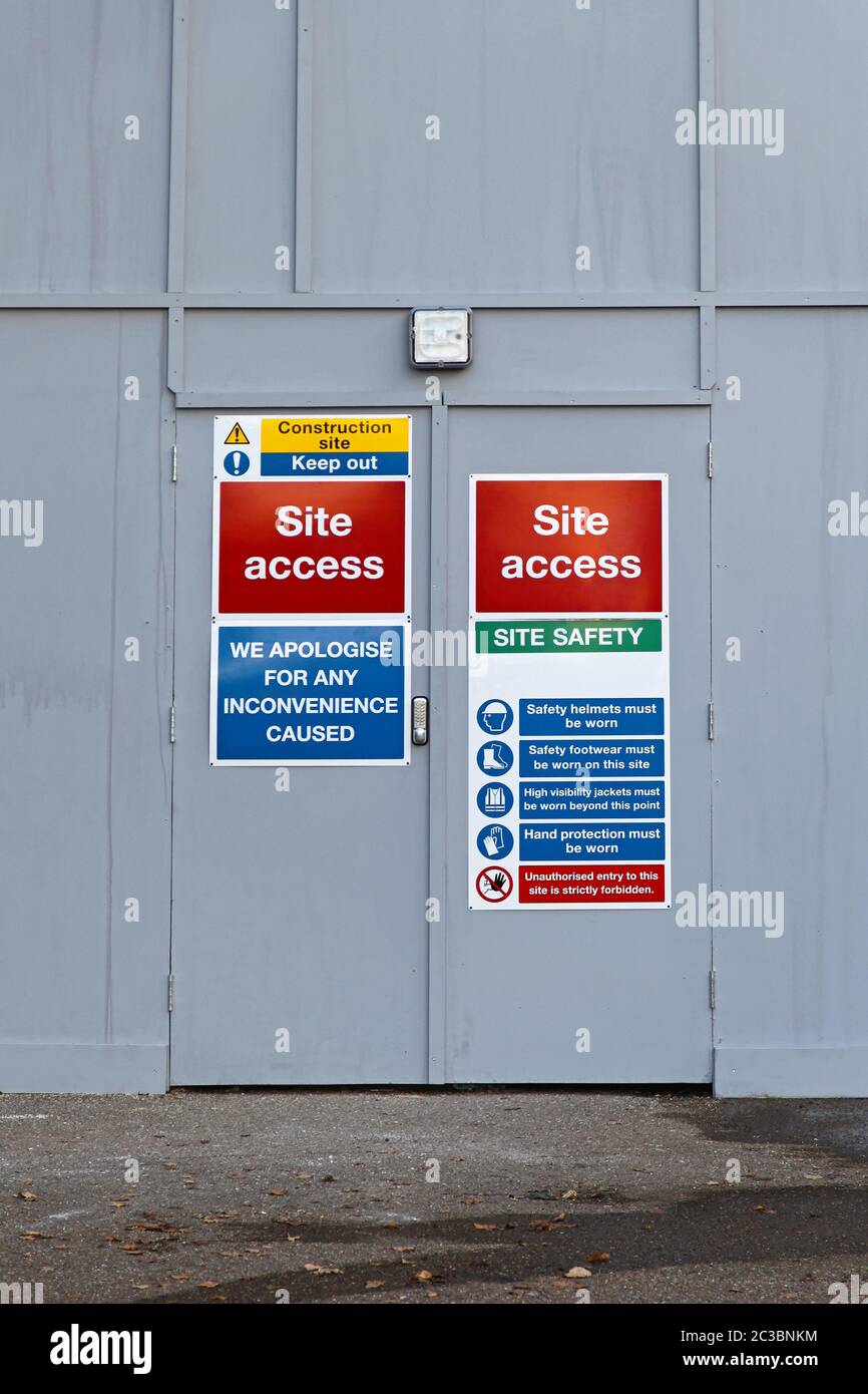 Construction site access door with warning signs Stock Photo - Alamy