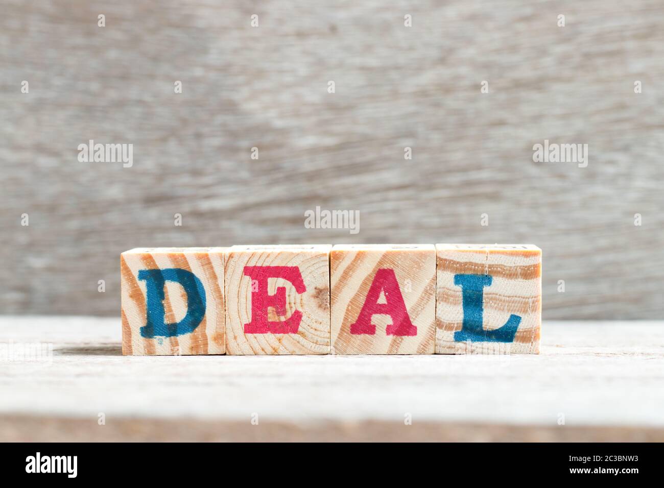 Alphabet letter block in word deal on wood background Stock Photo - Alamy