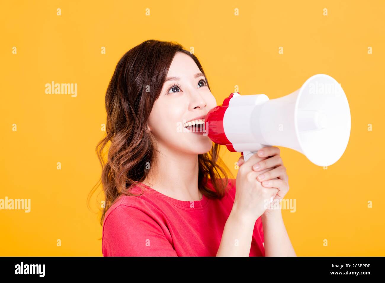 excited young woman with megaphone Stock Photo - Alamy