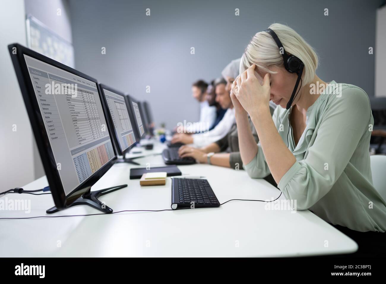 Young Depressed Businesswoman Sitting At Office Desk Stock Photo - Alamy