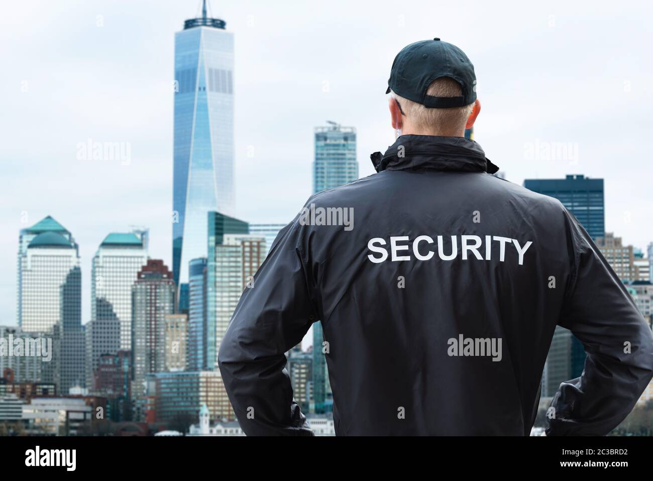 Male Security Guard Looking At City Skyline In Manhattan, New York ...