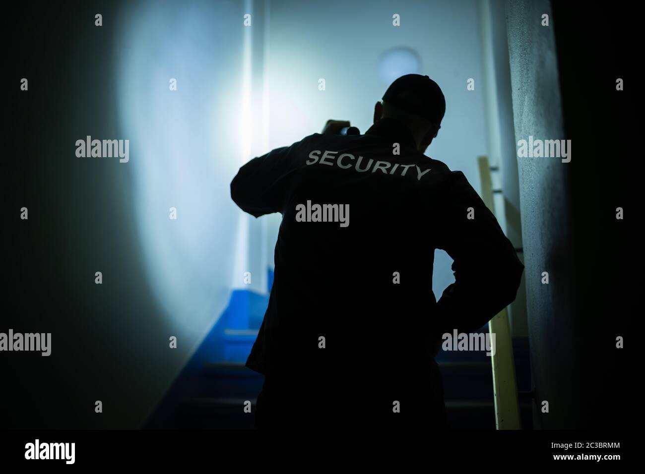 Security Guard Searching On Stairway With Flashlight Stock Photo - Alamy