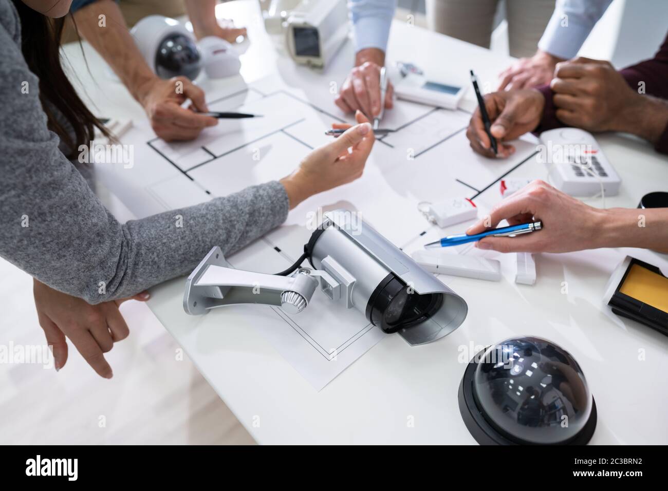 Group Of Security Engineers Working On Blueprint With Security ...