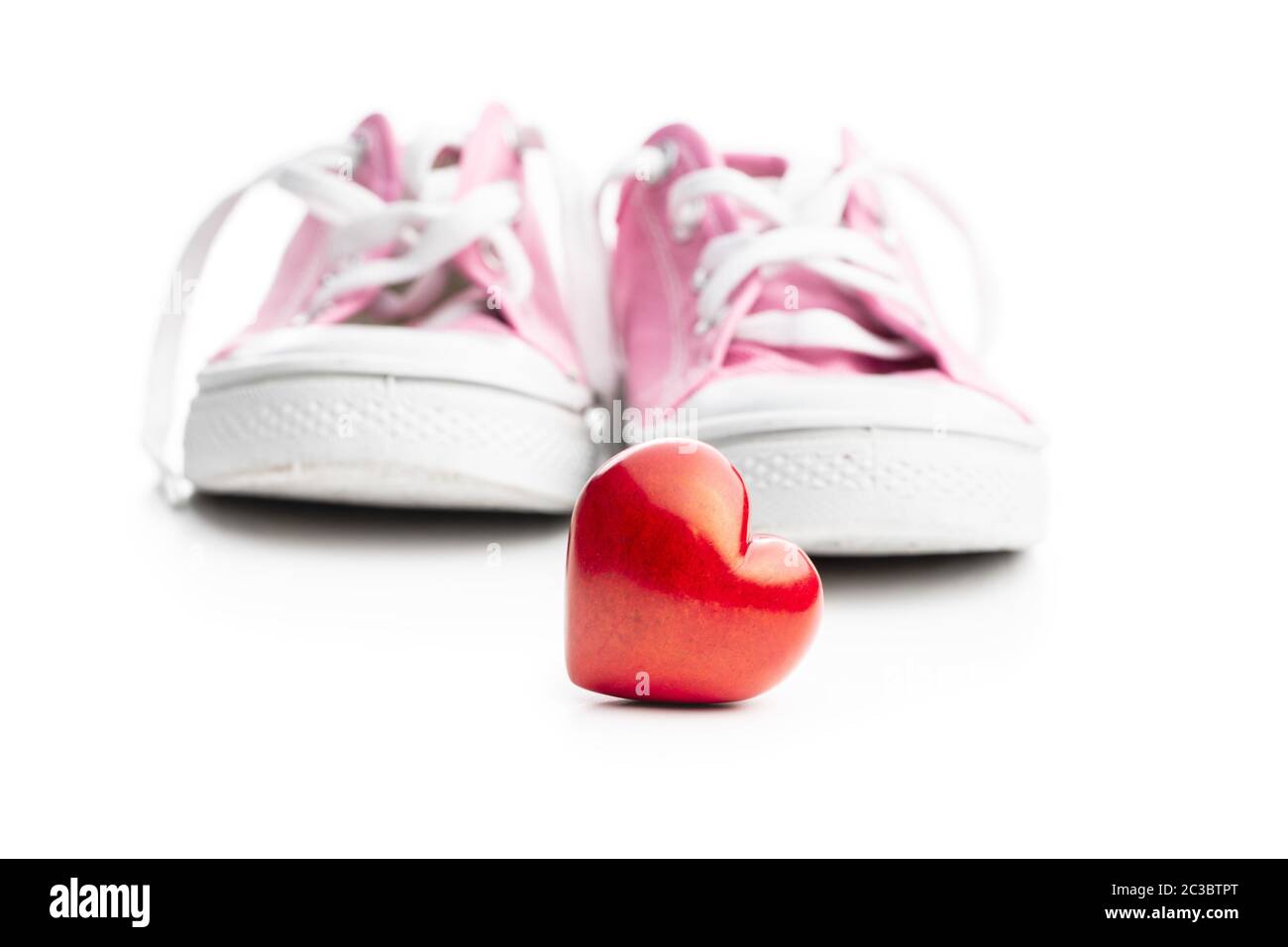 Valentine's Day love concept. Pink sneakers and red heart isolated on ...