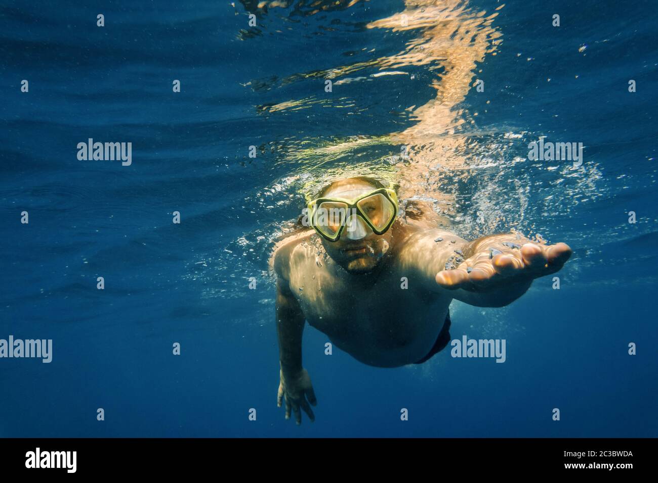 Male diver in blue water. Open sea, ocean, swimming, active travel and ...