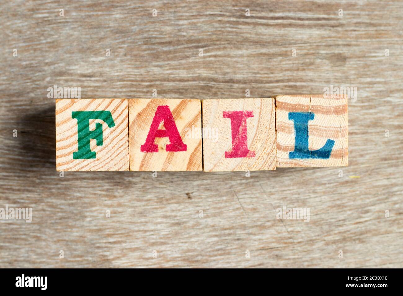 Letter block in word fail on wood background Stock Photo - Alamy
