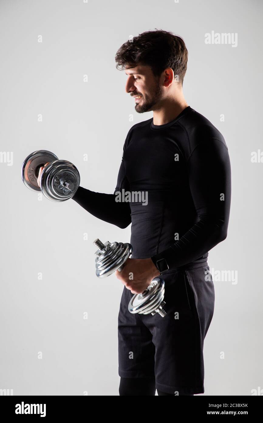 happy young man lifting dumbbells on white background Stock Photo - Alamy