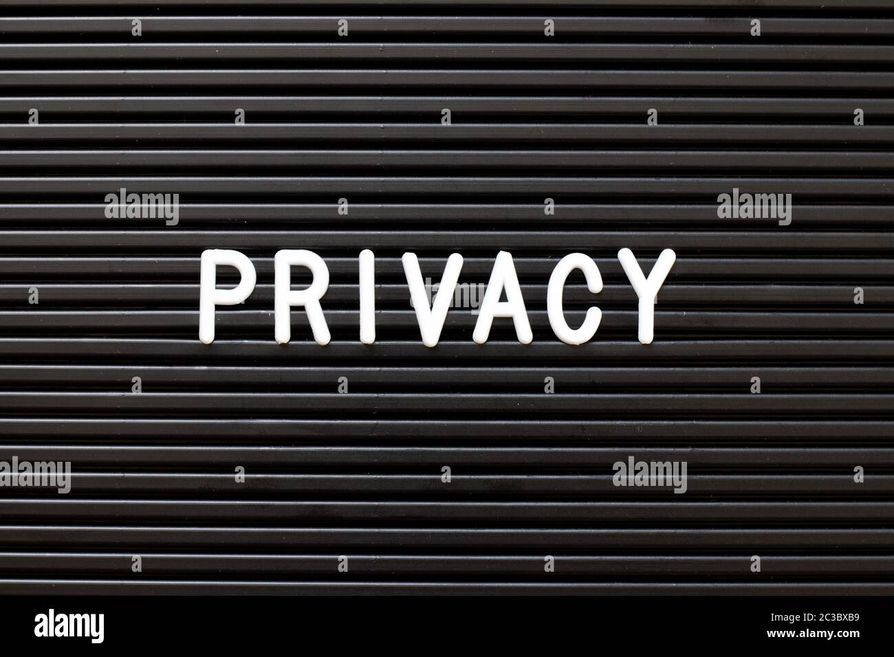 Black color felt letter board with white alphabet in word privacy ...