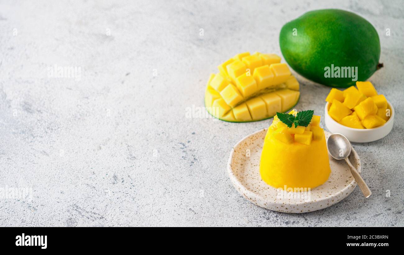 Mango Mousse on gray cement background with copy space left. Yellow ...