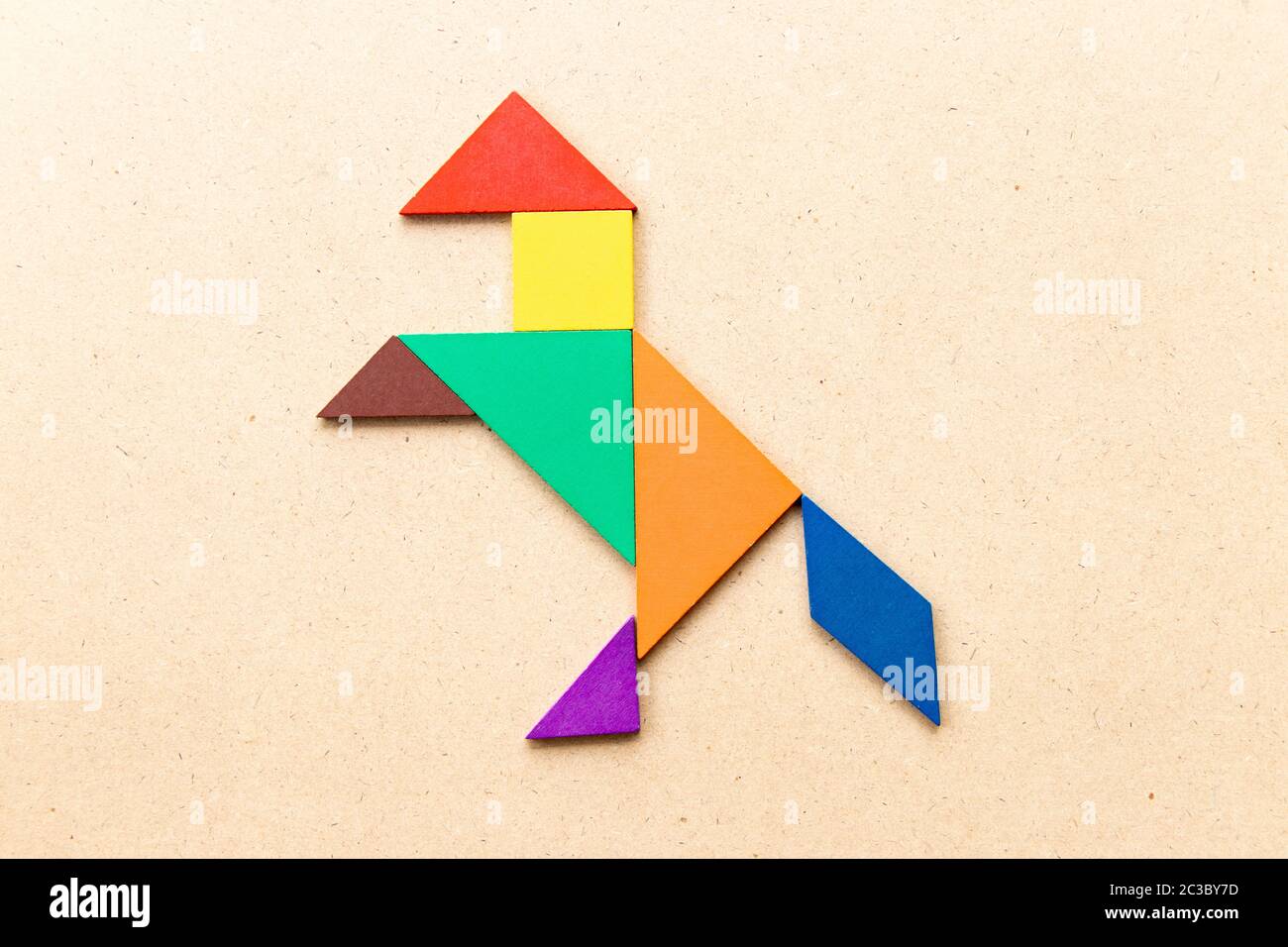 Color tangram puzzle in horse or mustang shape on wood background Stock ...