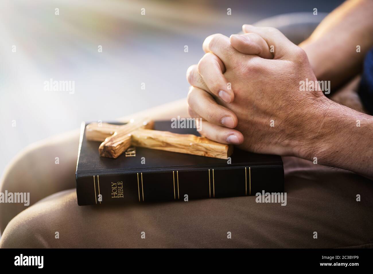 Sunlight Falling On Hand Over Bible While Praying Stock Photo - Alamy