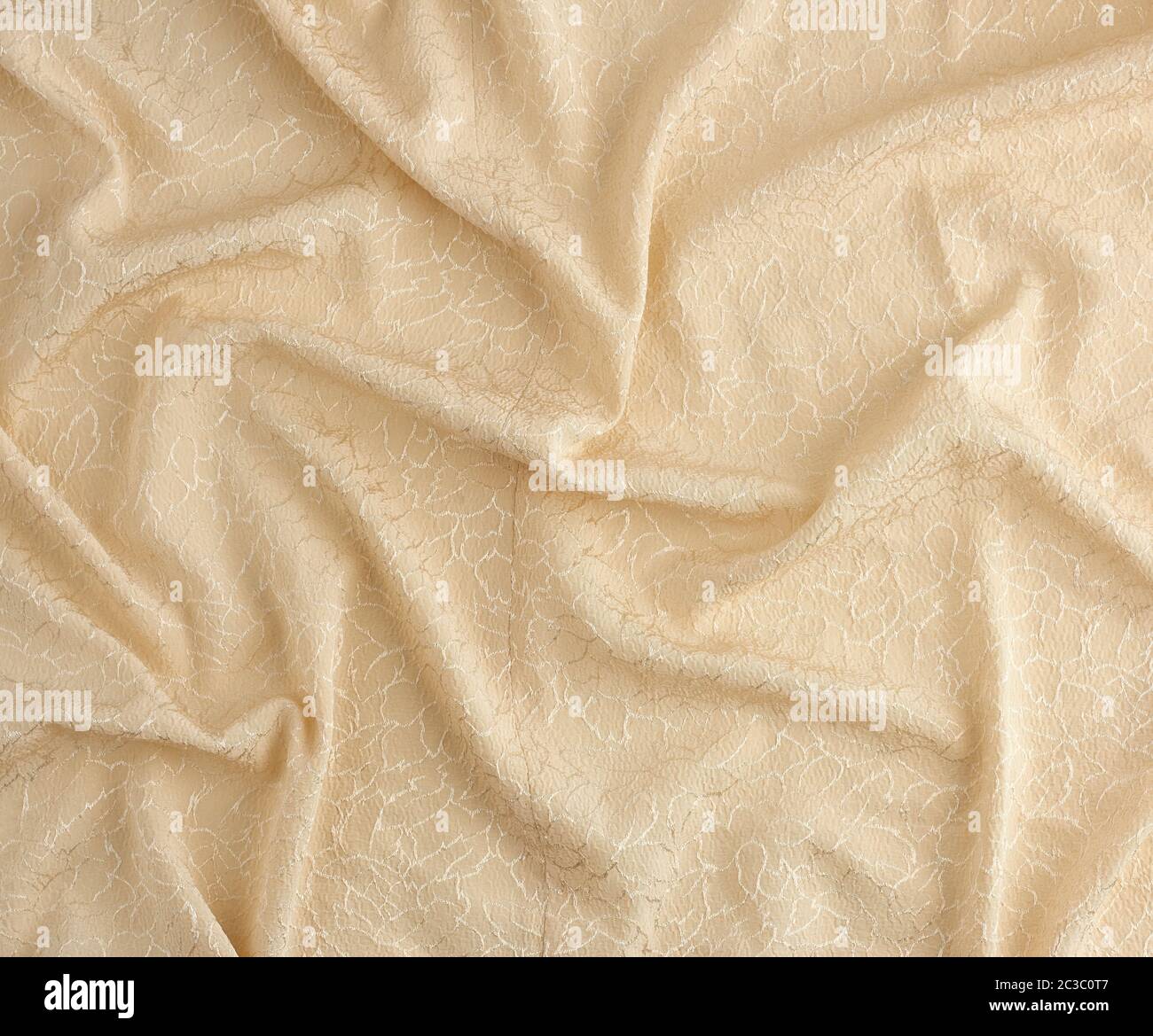 beige satin textile fabric with embroidery elements, piece of canvas ...