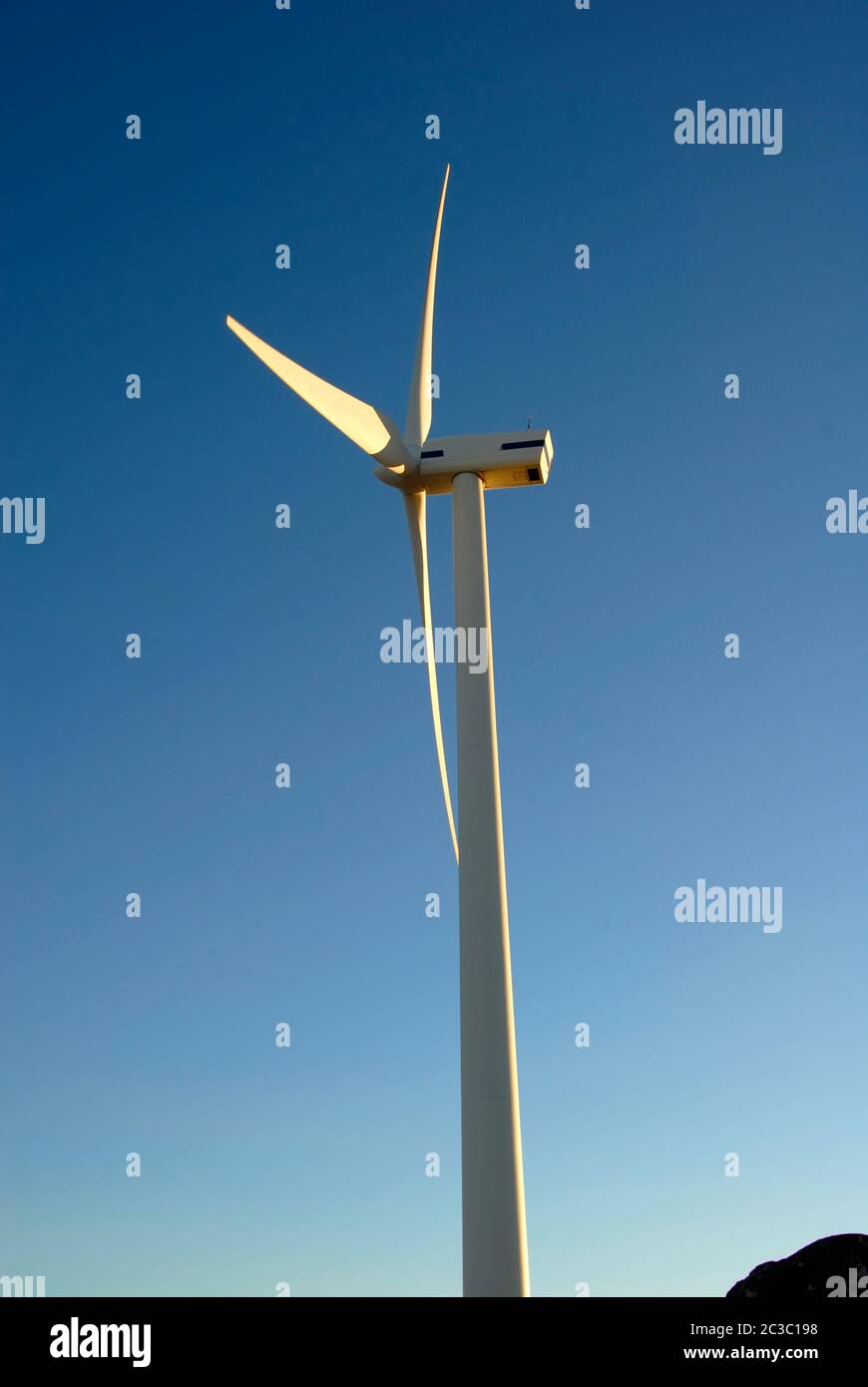 Modern white wind turbine or wind mill producing energy Stock Photo - Alamy