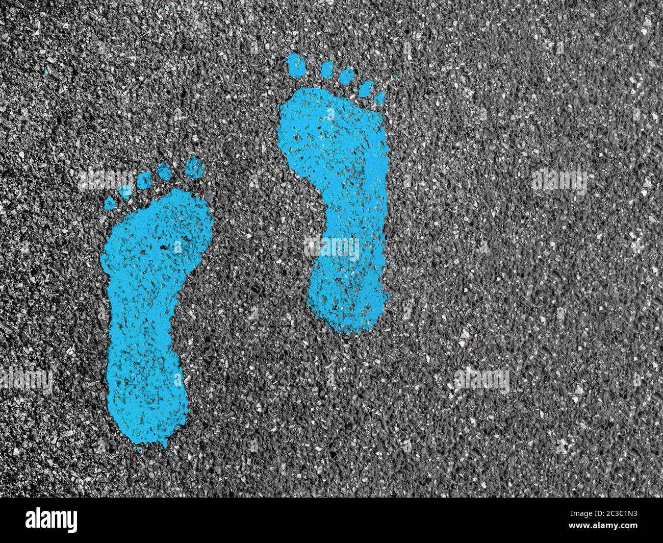 Blue footprint signs on an asphalt road for pedestrian. Symbol of ...