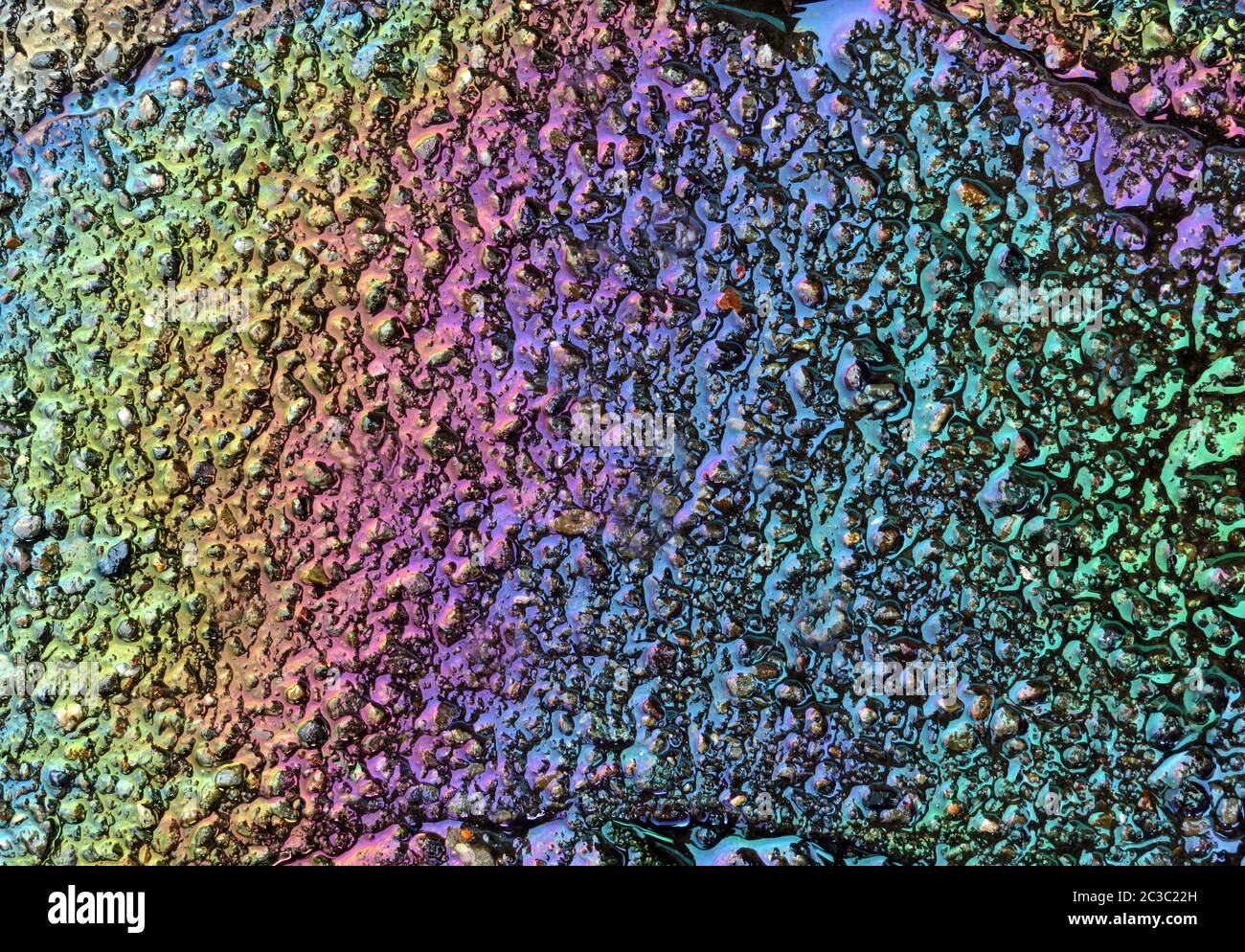 Gasoline puddle on a wet cobblestone Stock Photo - Alamy