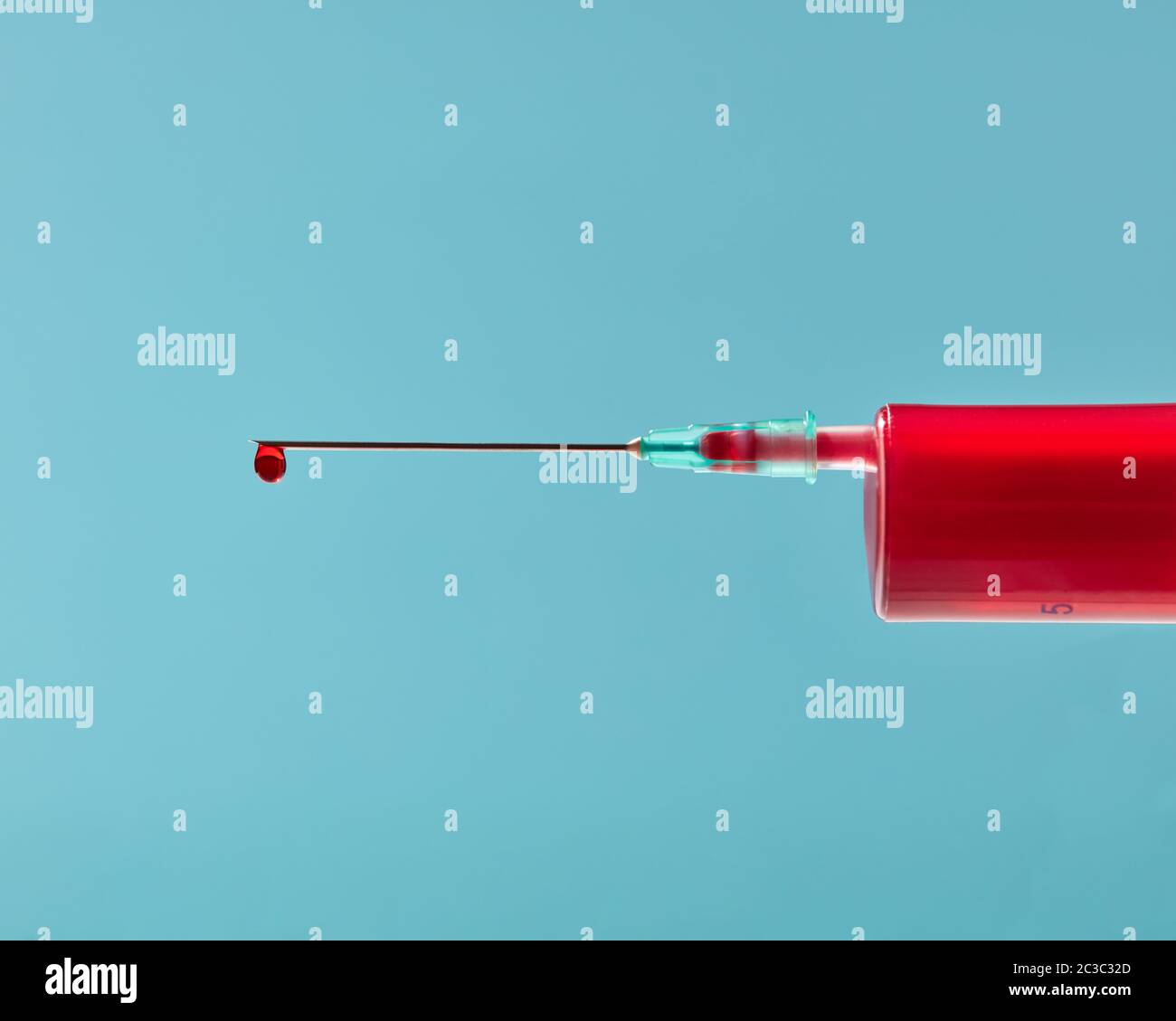 Close-up needle of plastic syringe with drop of red liquid Stock Photo ...