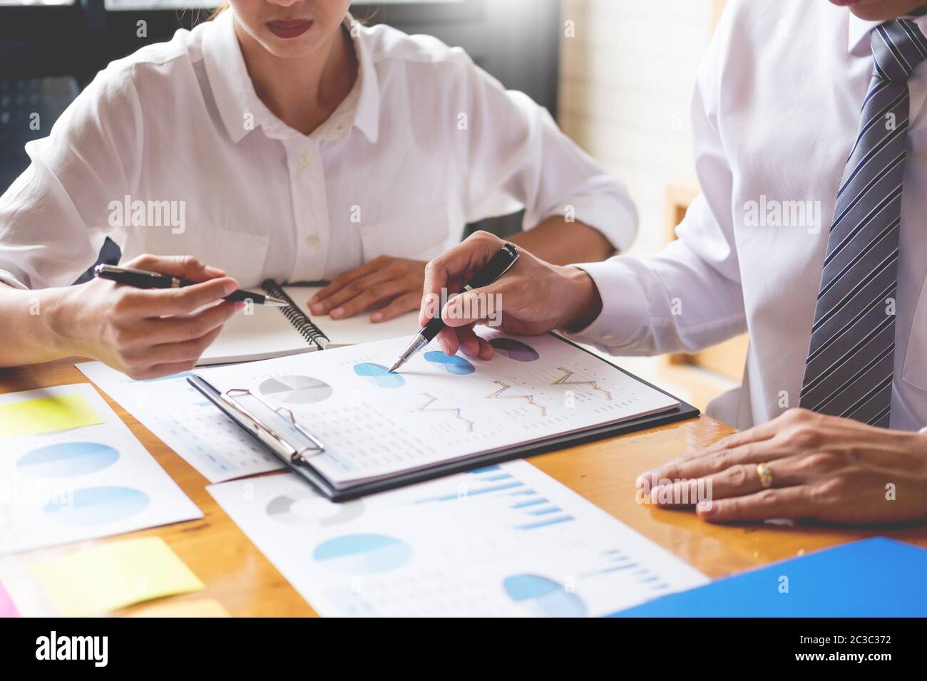 Business team data analyzing income charts document during discussion ...