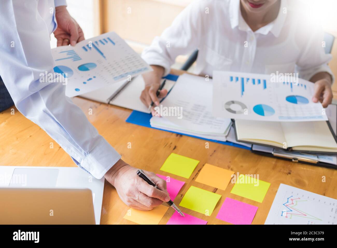 Business team data analyzing income charts document during discussion ...