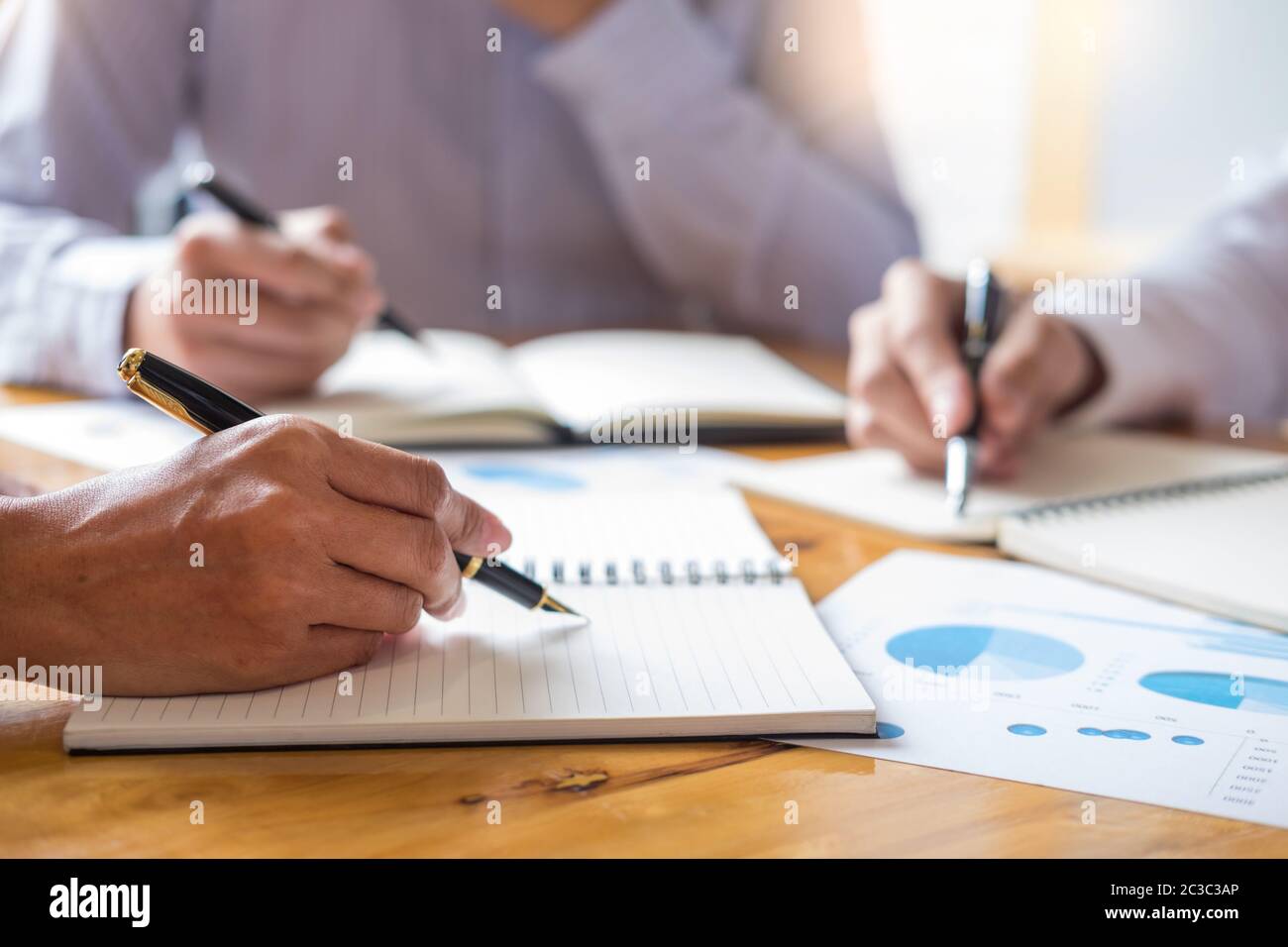 Business team data analyzing income charts document during discussion ...