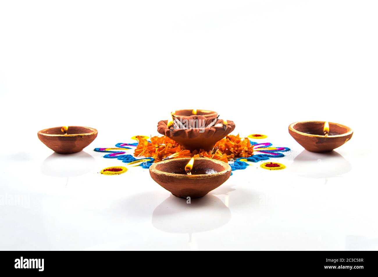 Clay diya lamp lit during diwali festival. Clay Diya on Rangoli. Happy ...