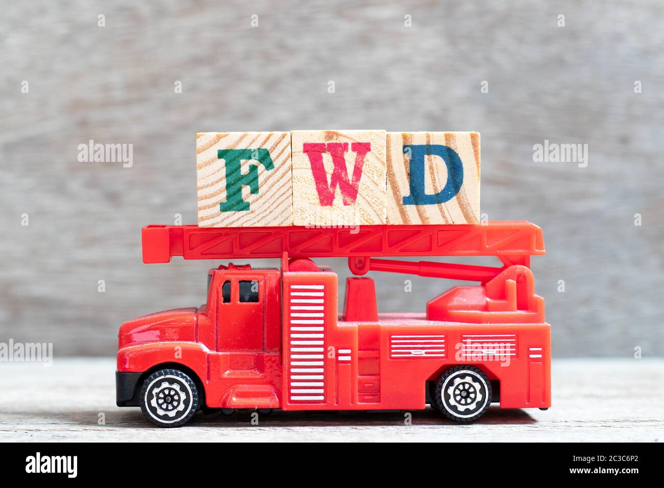Red fire truck hold letter block in word FWD (Abbreviation of forward ...