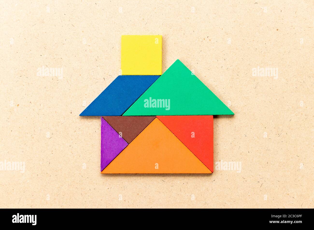 Color tangram puzzle in house or home shape on wood background Stock ...