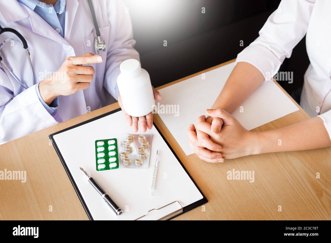 doctor hand holding tablet of drug and explain to patient in hospital ...
