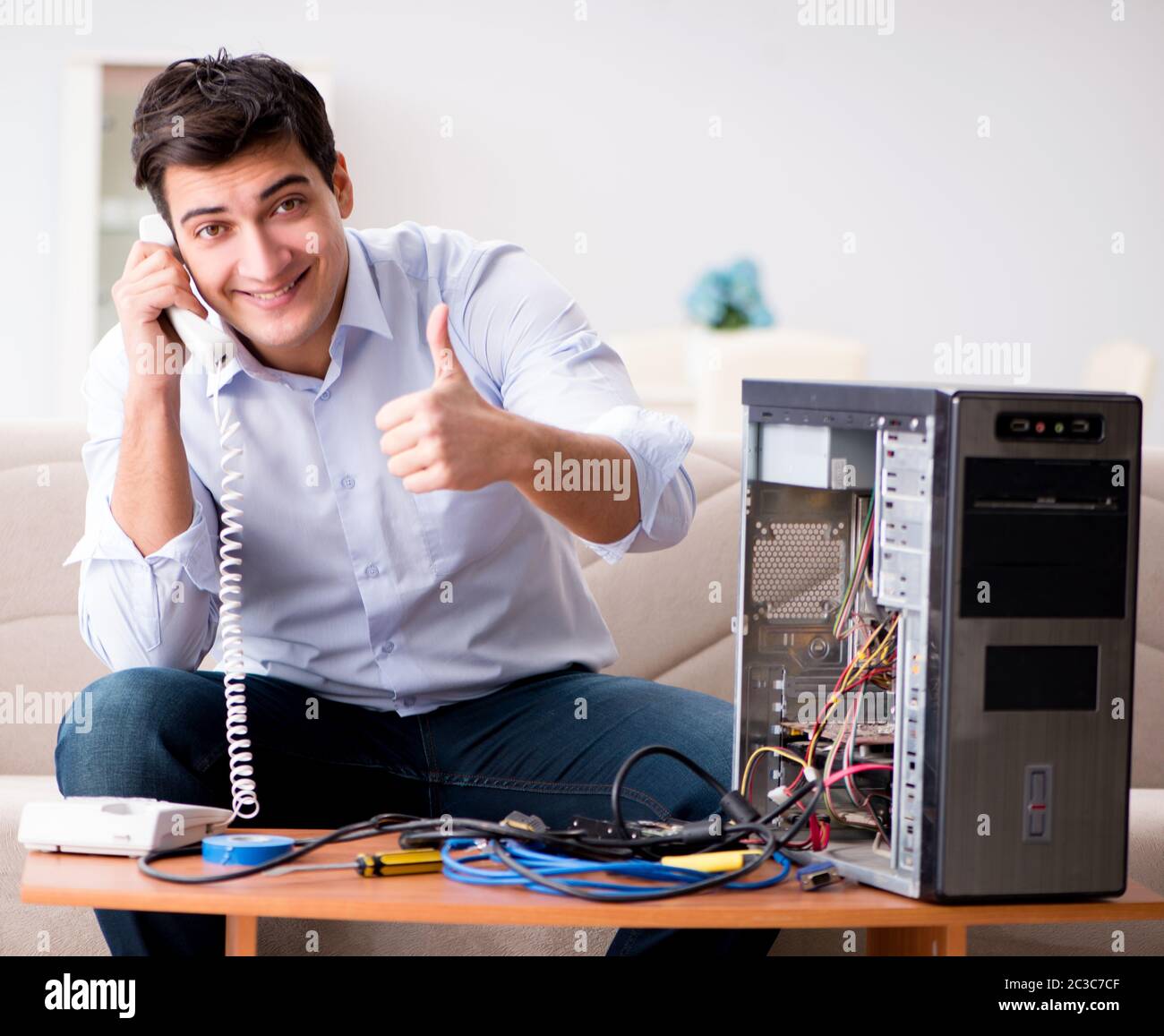 Happy customer resolving his computer problem Stock Photo - Alamy