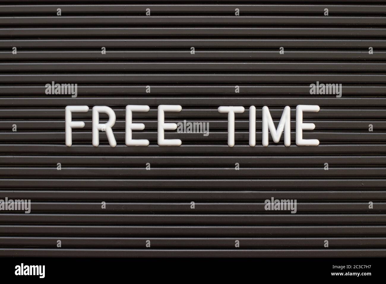Black color felt letter board with white alphabet in word free time ...