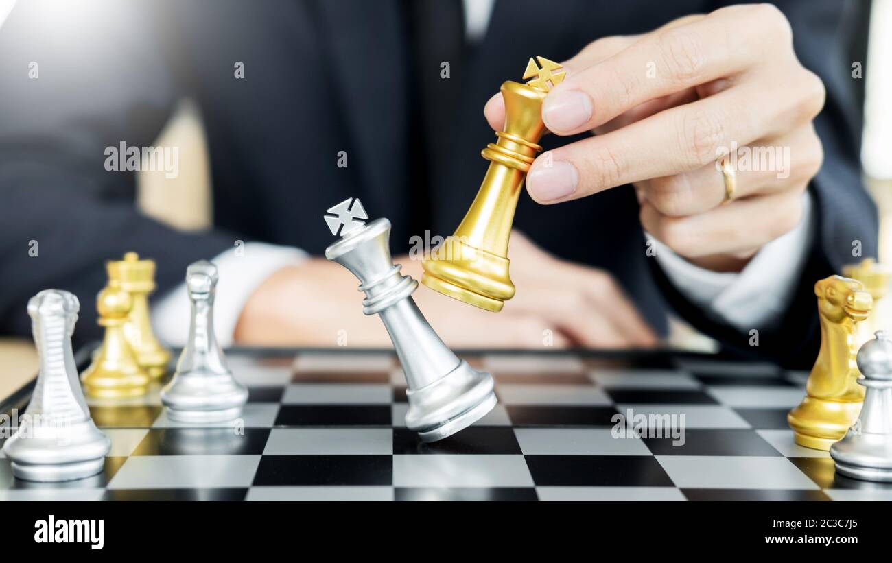 businessman playing chess figure take a checkmate another king with ...
