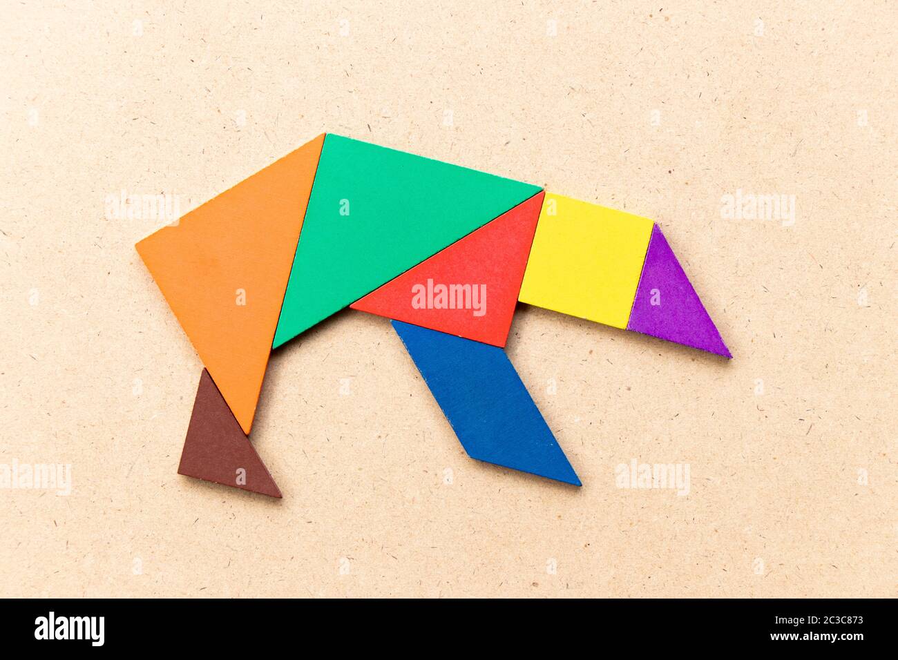 Color tangram puzzle in bear shape on wood background Stock Photo - Alamy