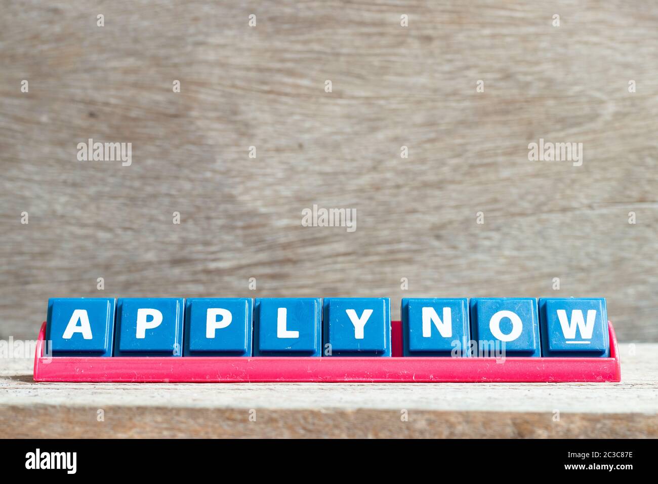 Tile letter on red rack in word apply now on wood background Stock ...