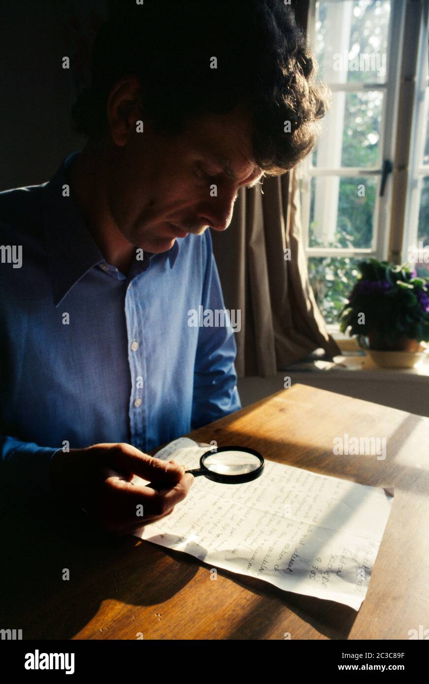 A Graphologist Analyzing Someones Handwriting using a Magnifying Glass ...