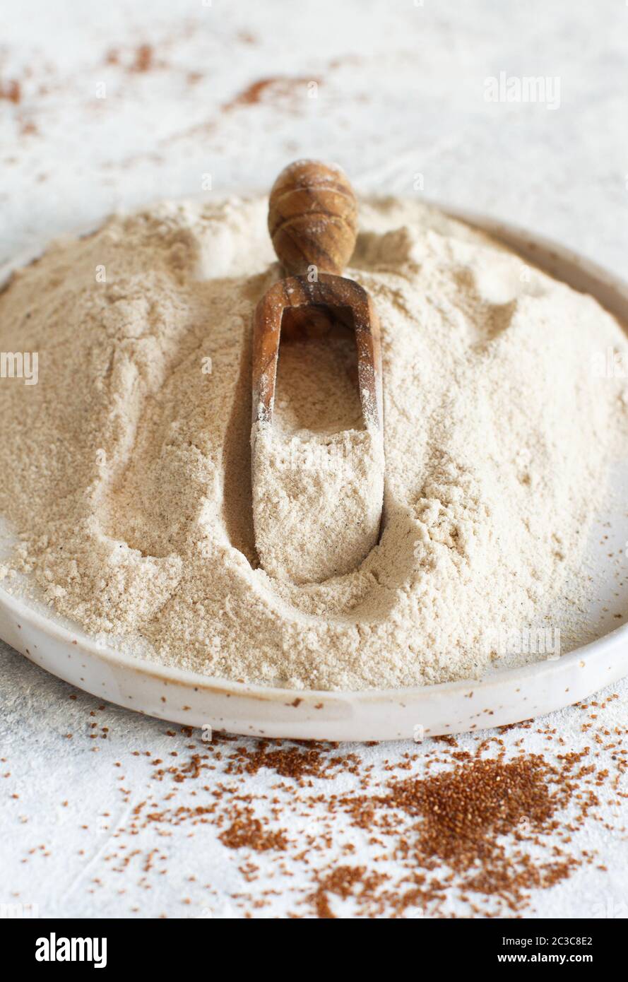 Teff flour in a plate with a spoon close up Stock Photo - Alamy