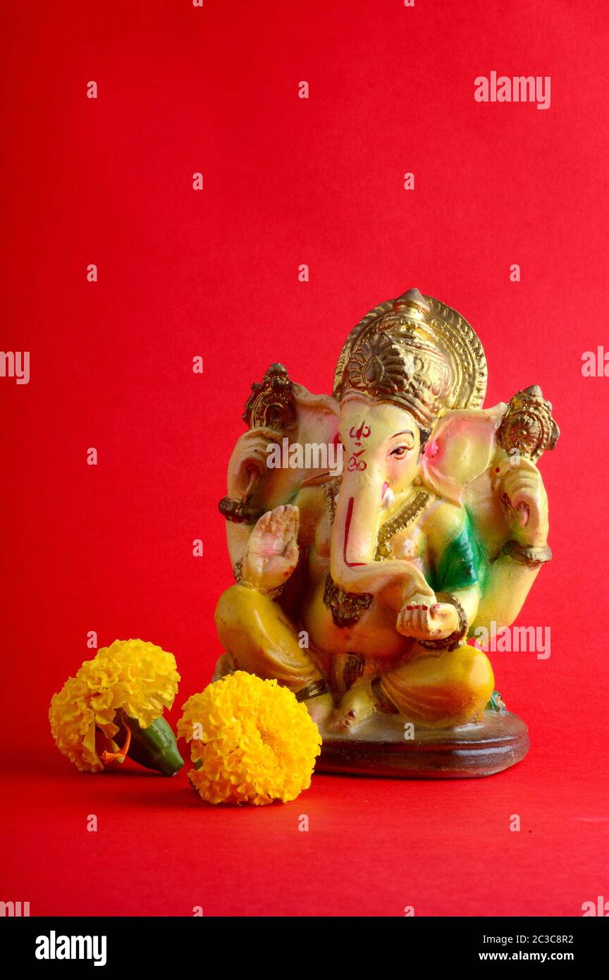 Hindu God Ganesha. Ganesha Idol on red Background Stock Photo - Alamy