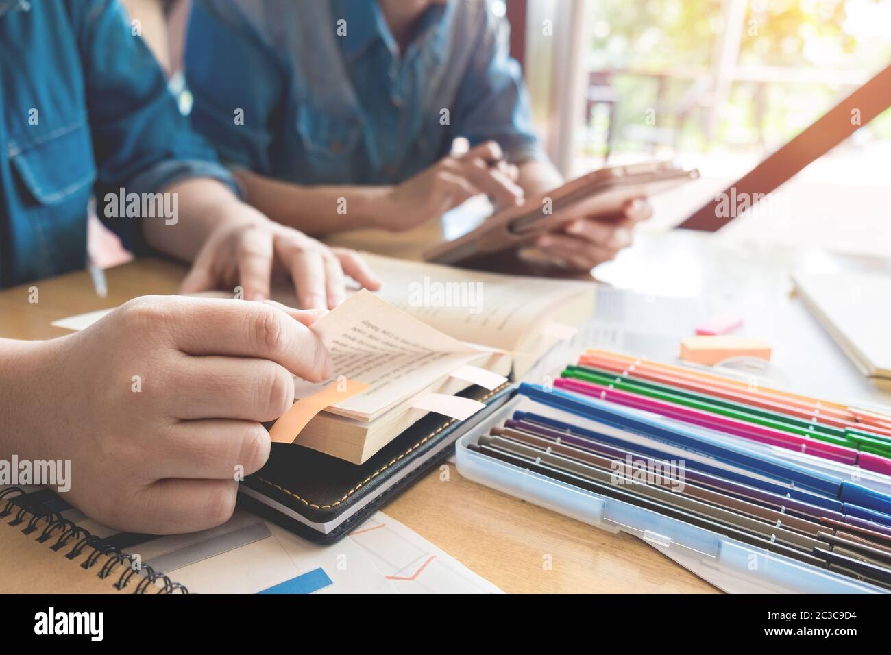 Young students campus helps friend catching up and learning. People ...