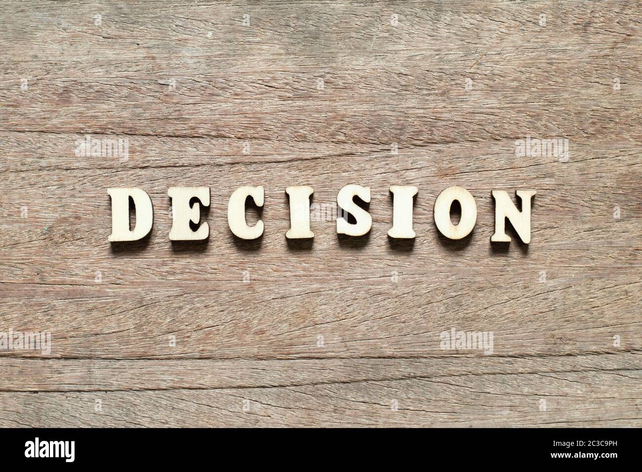 Letter block in word decision on wood background Stock Photo - Alamy