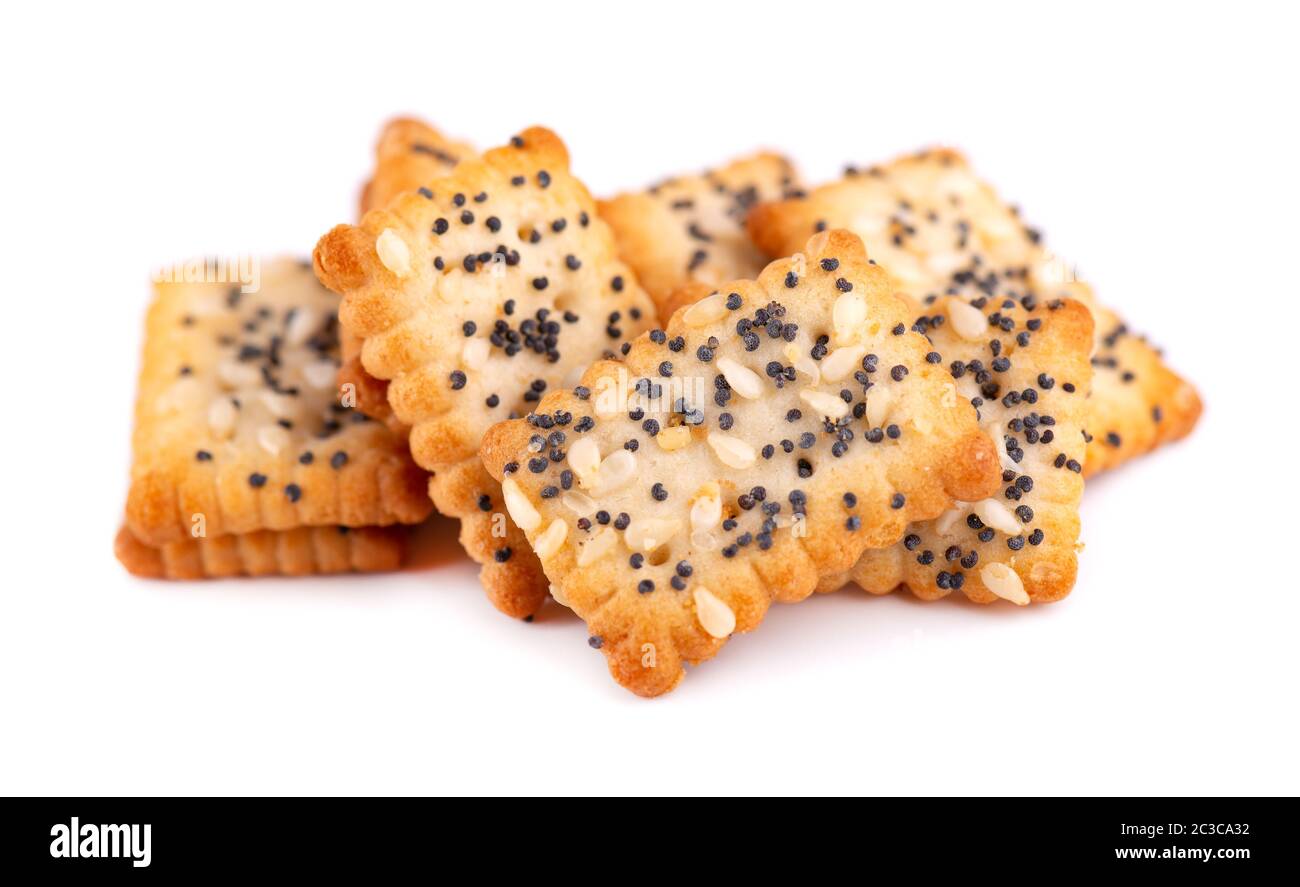 Square poppy seeds and sesame crackers isolated on white background. Dry cracker cookies ...