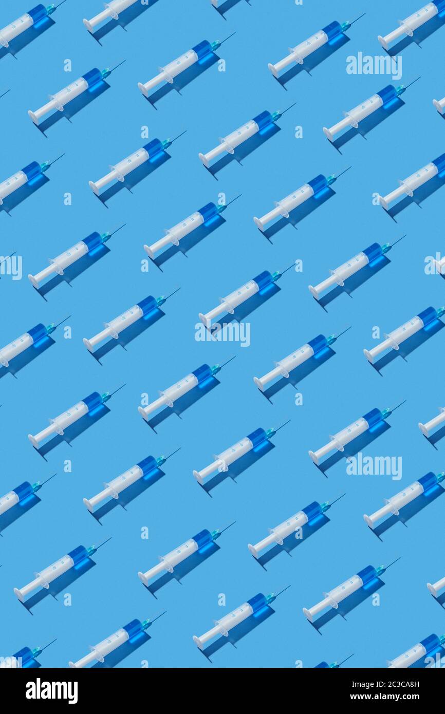 Medical pattern of disposable syringes with blue injectable liquid ...