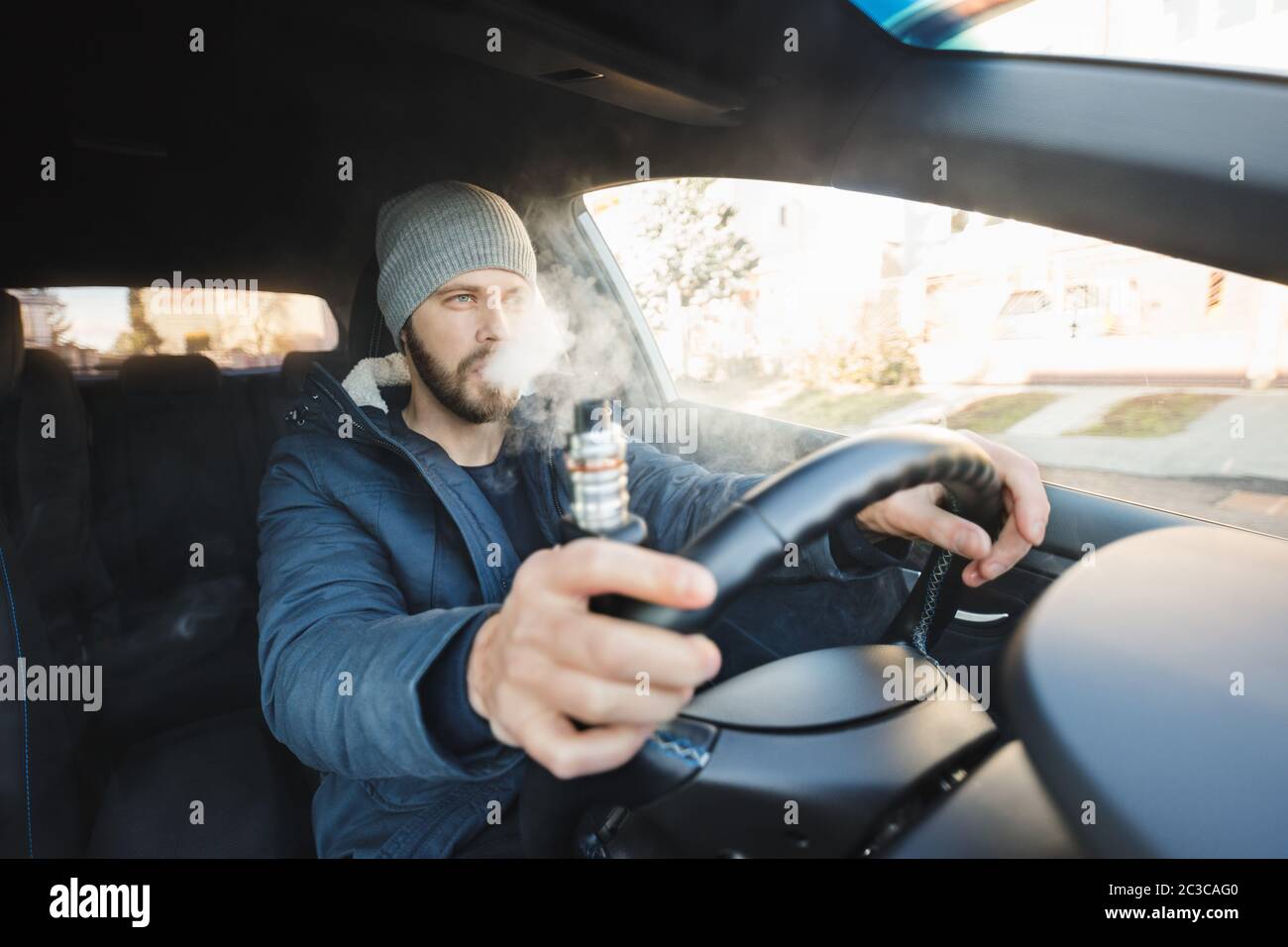 Vaping flavored e-liquid from an electronic cigarette in a car Stock ...