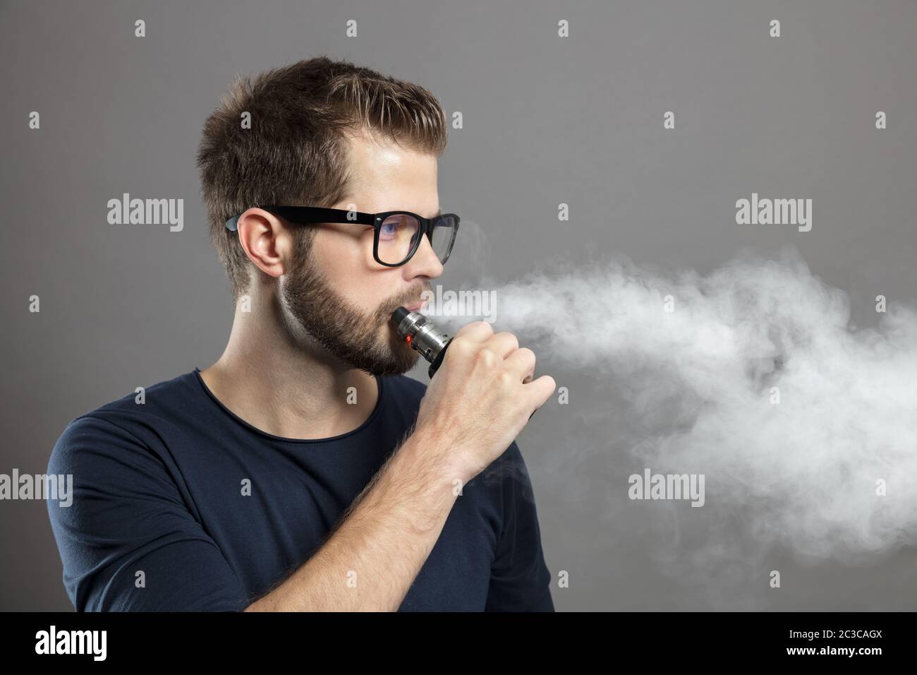 Vaping flavored e-liquid from an electronic cigarette Stock Photo - Alamy